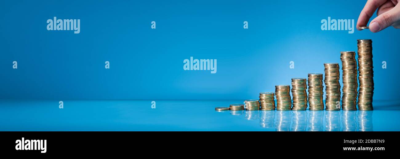 Financial Money Graph With Pile Of Coins. Salary Growth Stock Photo - Alamy