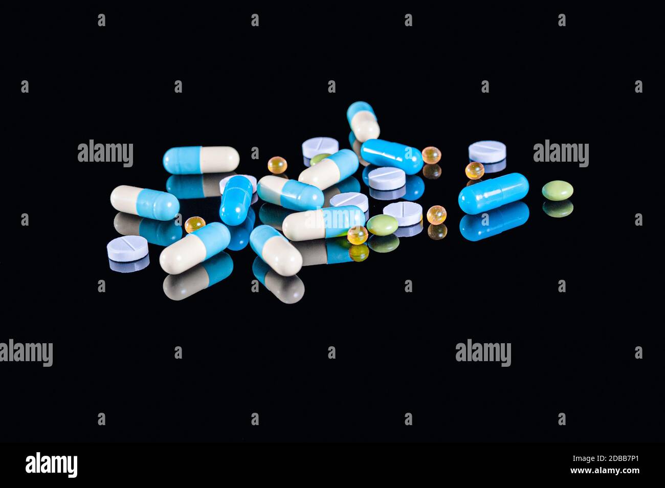 Different tablets, pills and capsules of different colors on an ...