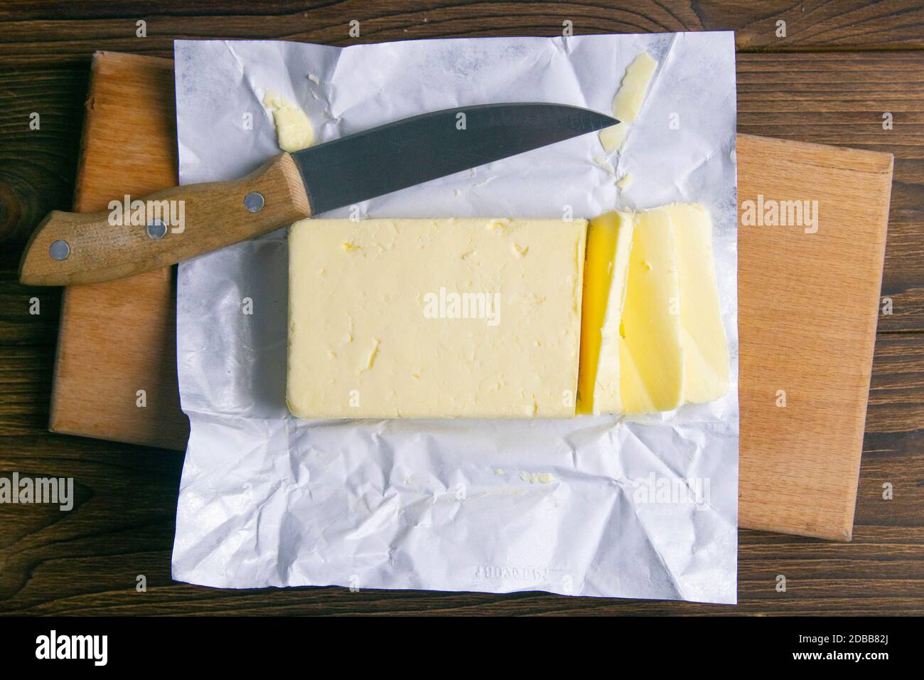 Piece of unwrapped butter on wooden table. Top views, close-up Stock ...