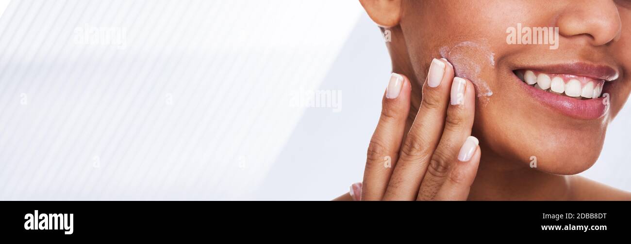 African American Woman Face Skincare. Applying Cream Stock Photo - Alamy