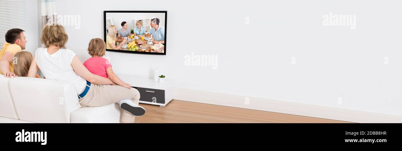 Family Watching TV Soap Opera At Home Stock Photo - Alamy