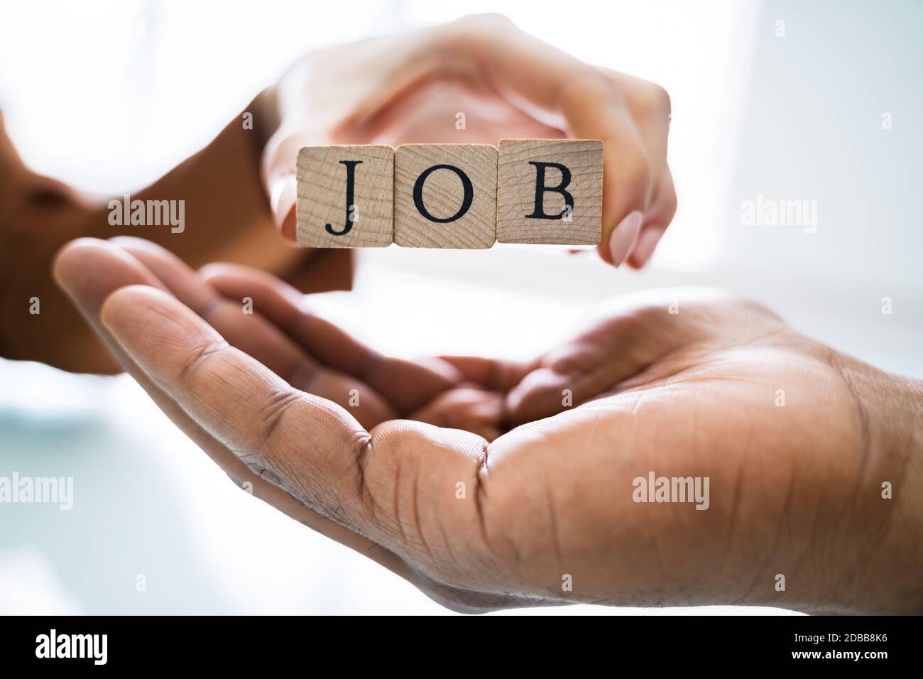 Close-up Of Businessperson's Hand Giving Wooden Block With Job Text To ...