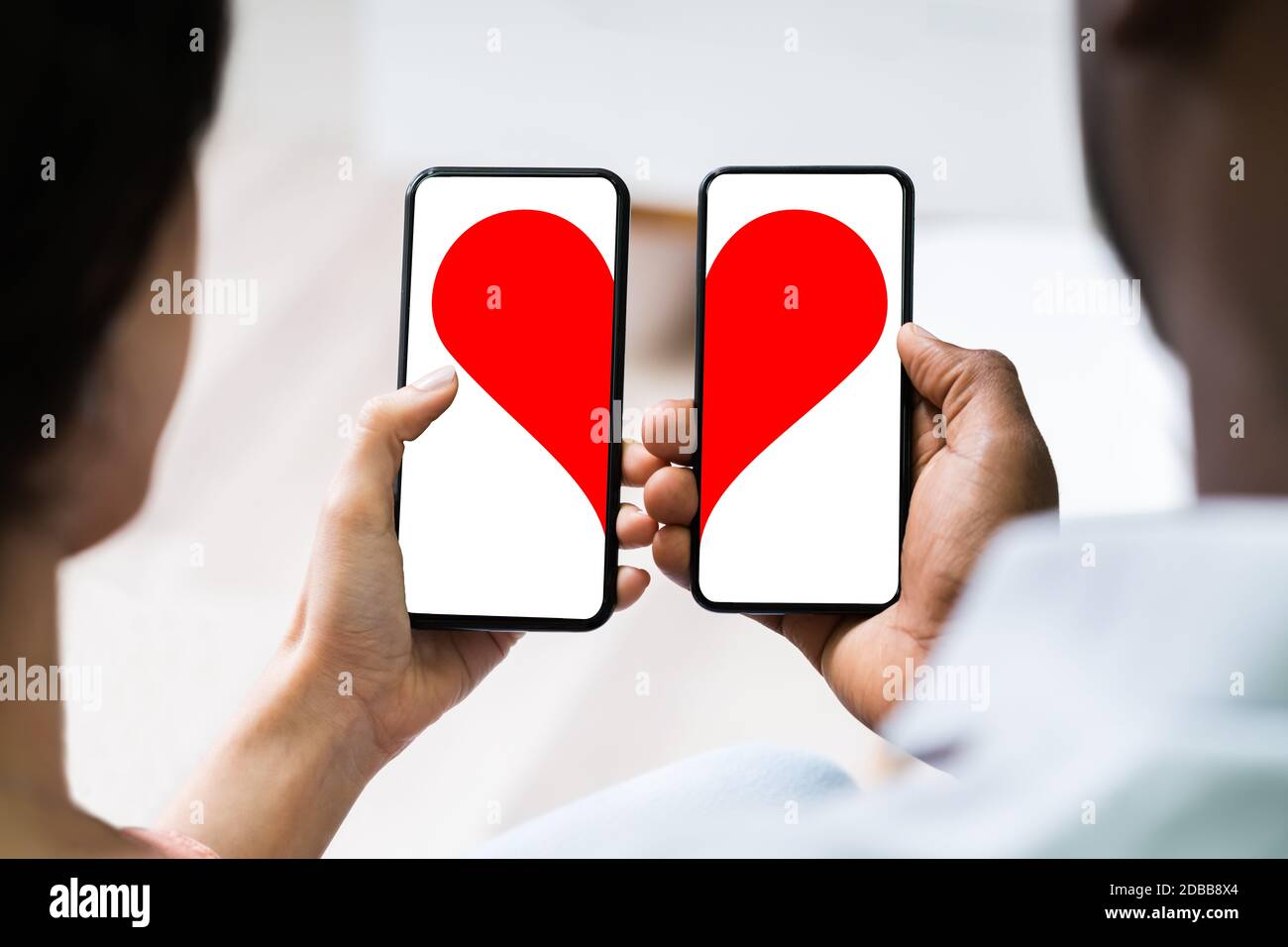 Couple Holding Cellphone With Half Heart Symbol On Screen Stock Photo ...
