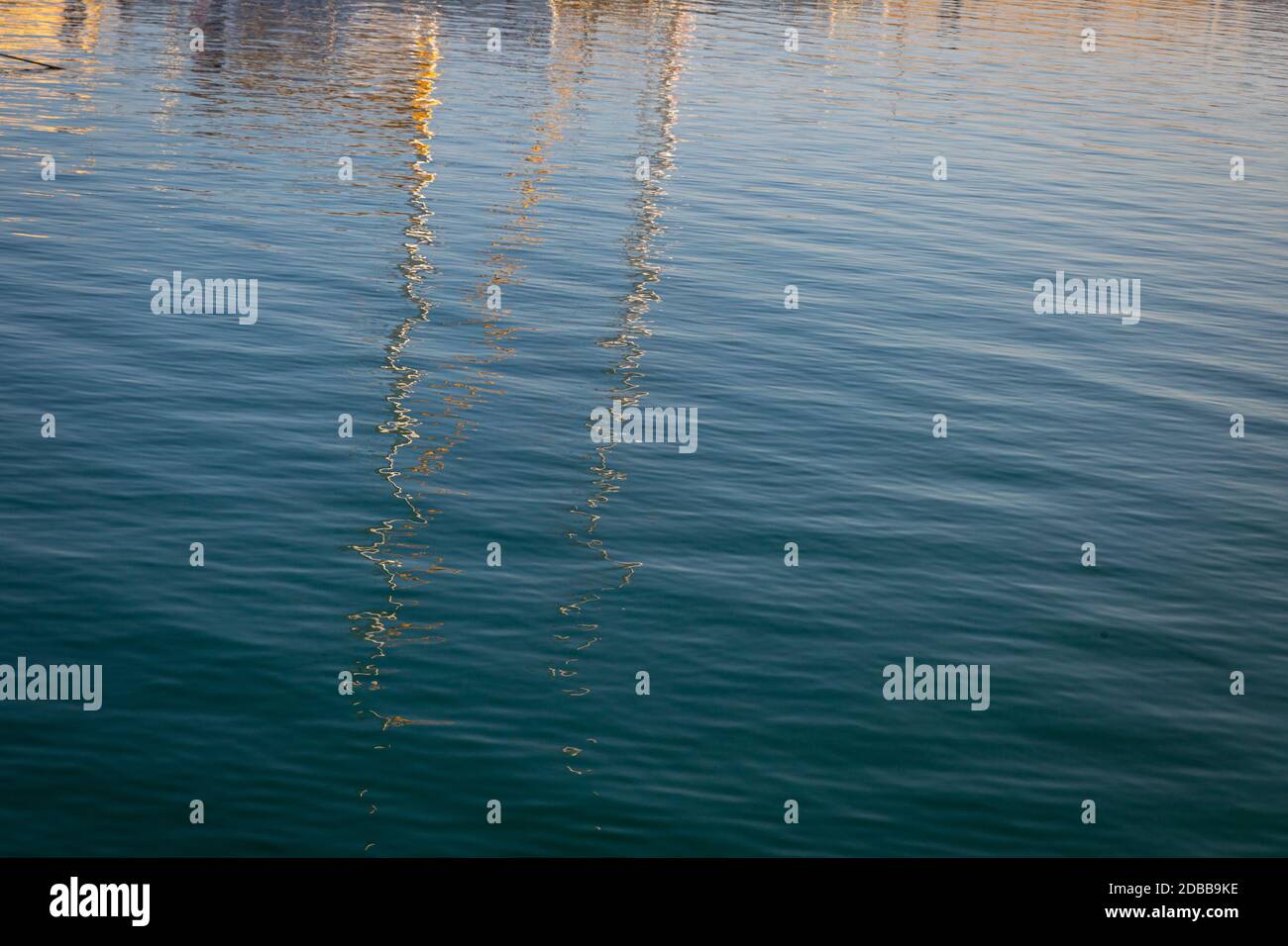 Reflections of boats in the harbor on sea water Stock Photo - Alamy