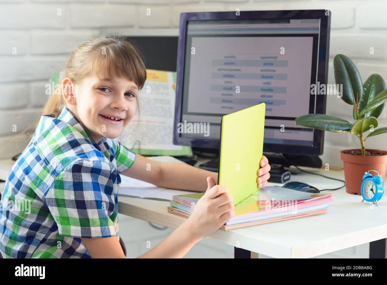 Girl enjoys doing homework at the computer Stock Photo - Alamy