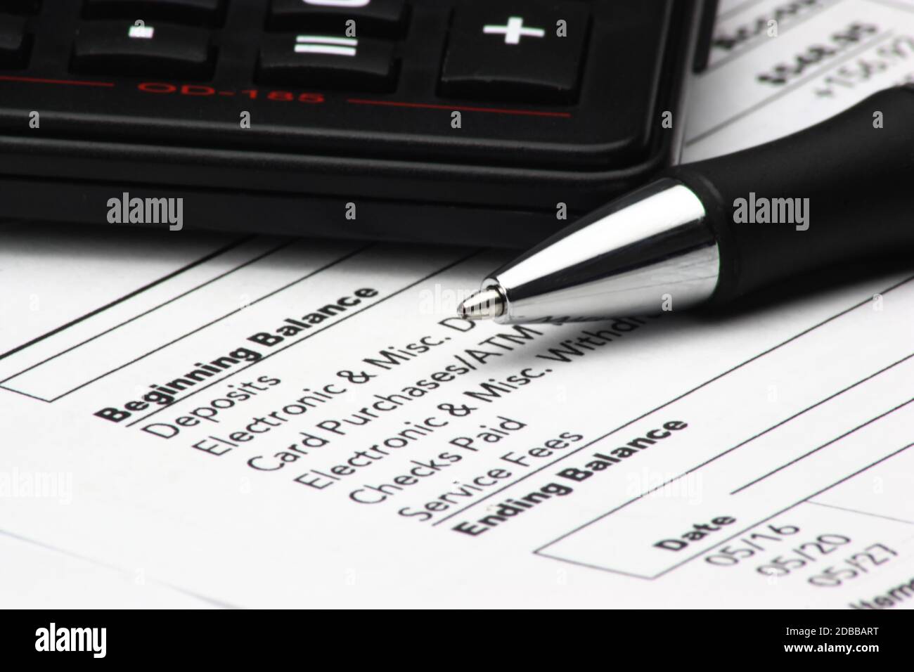 A standard calculator and pen on top of a bank statement Stock Photo ...