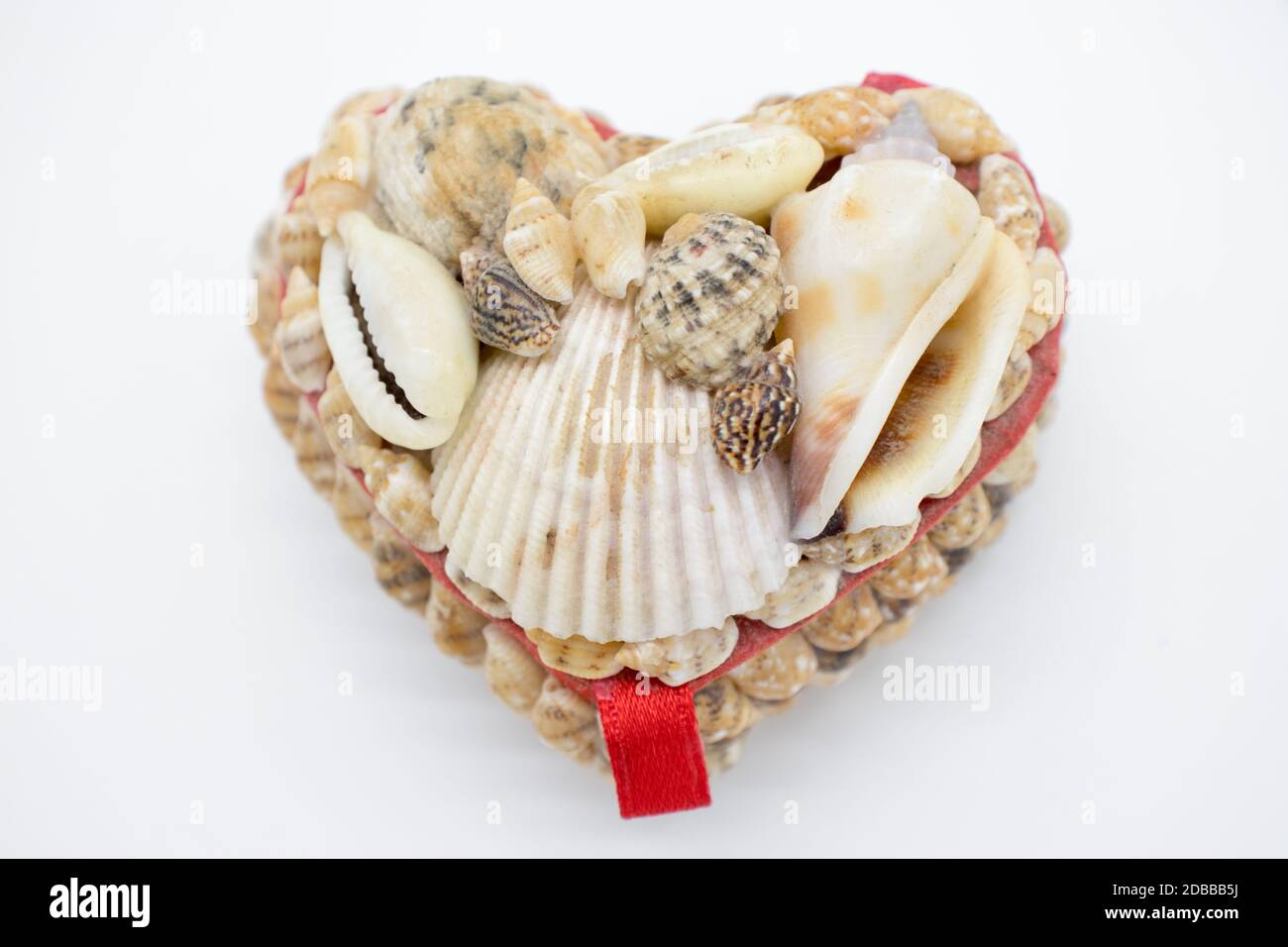 Heart-shaped handmade jewelry box made of seashells on white background ...