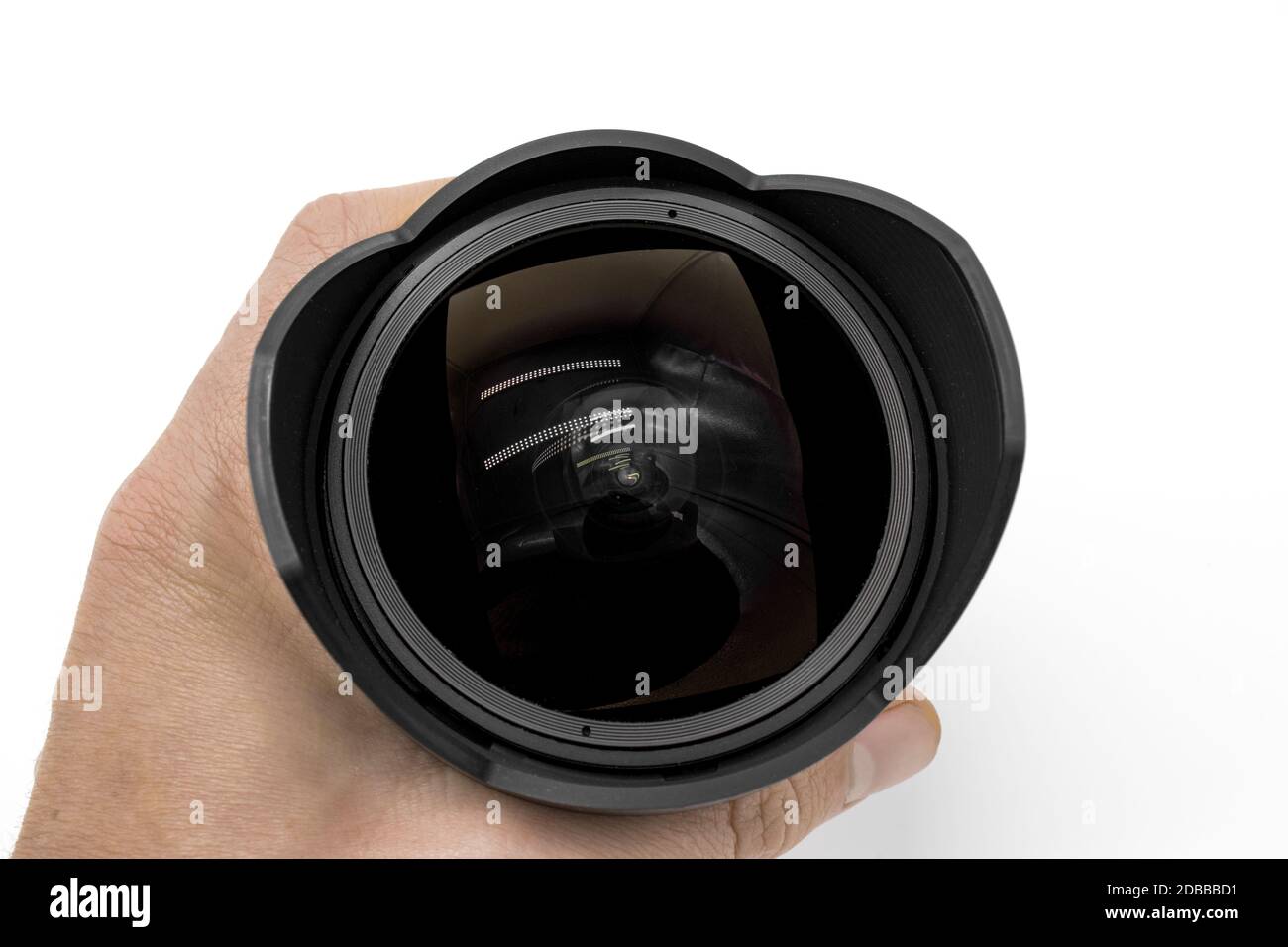 Hand holds black fisheye lens on white background Stock Photo - Alamy