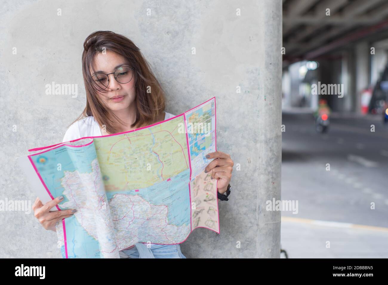 Women traveler looking a map for plan travel at the city Stock Photo ...