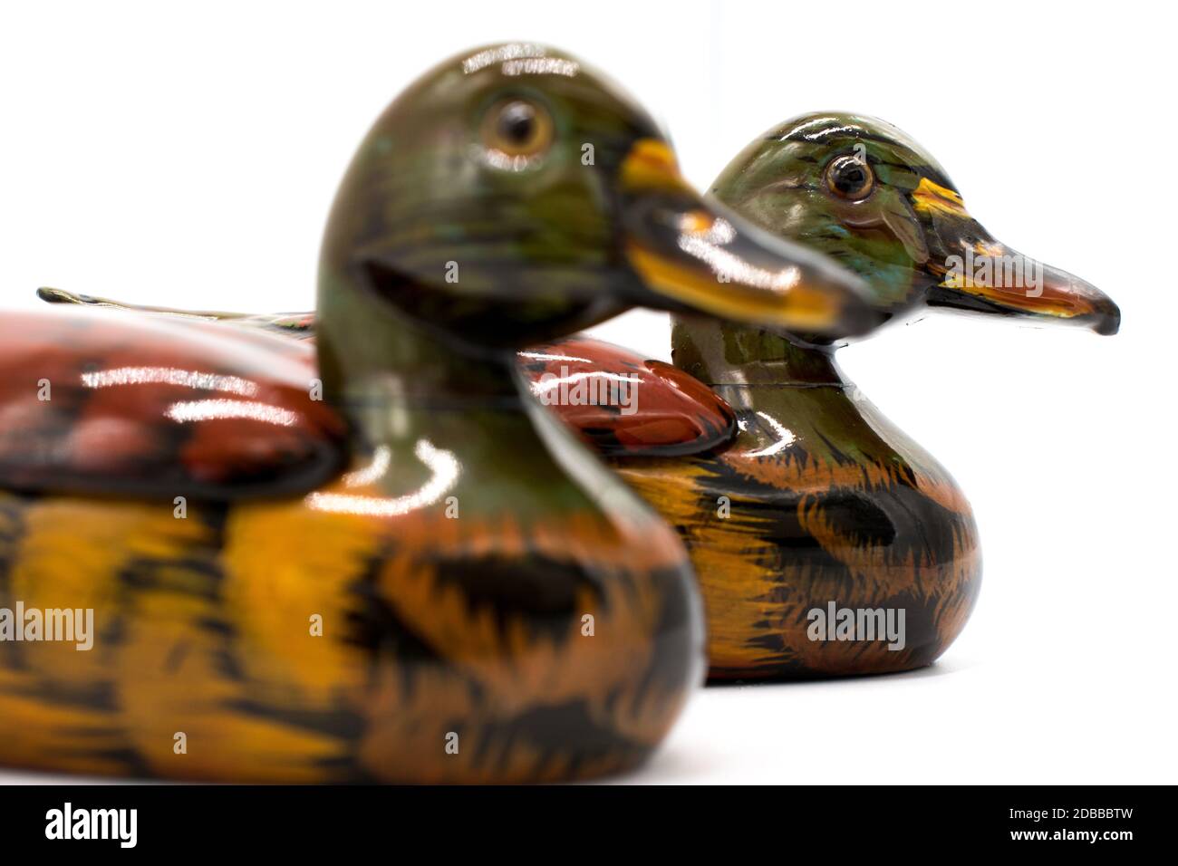 Handmade wood figurines of ducks on a white background Stock Photo - Alamy