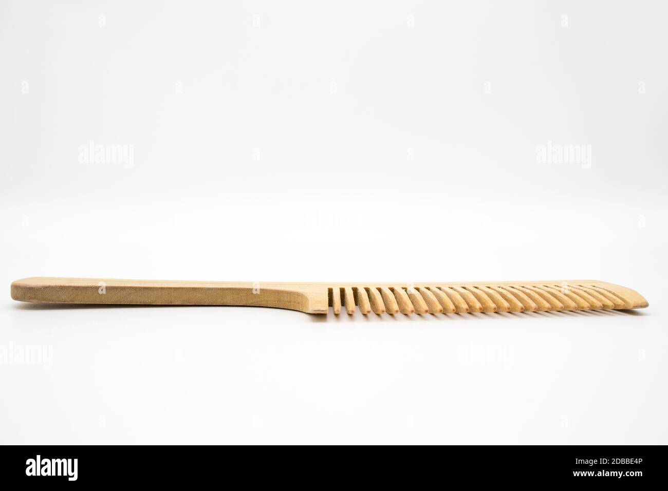 Wooden comb with handle on white background Stock Photo - Alamy