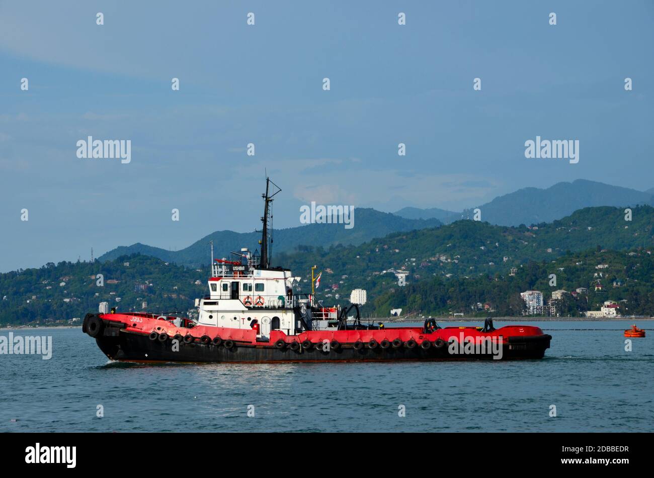 Red tug boat at sea with mountain background traveling in Black Sea ...