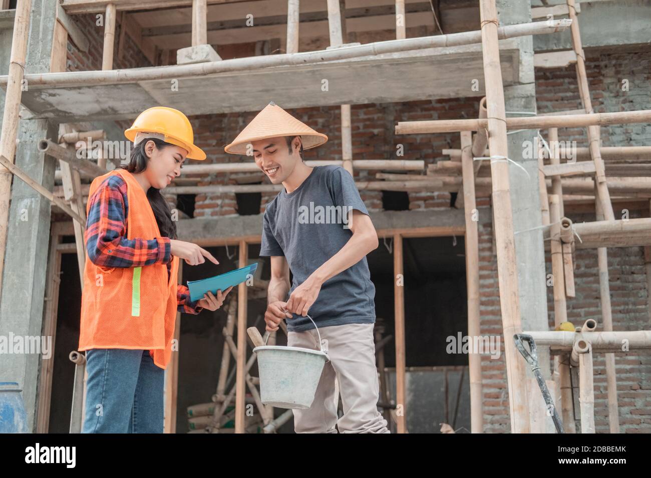 female contractors and builders discuss building designs in the ...
