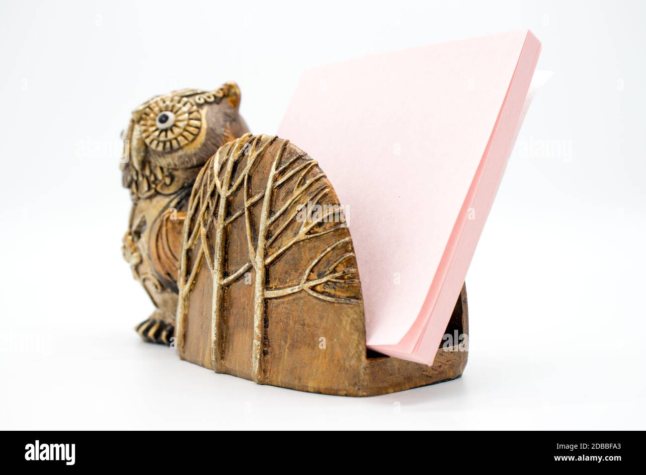 Sheet for notepad storage of notes, in a statue of an owl on a white ...