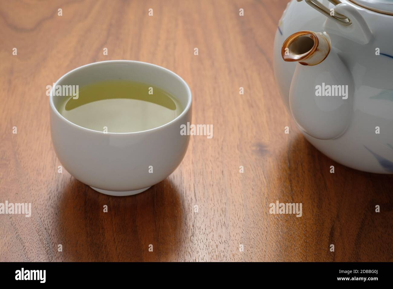 Cup of green tea with pot Stock Photo - Alamy
