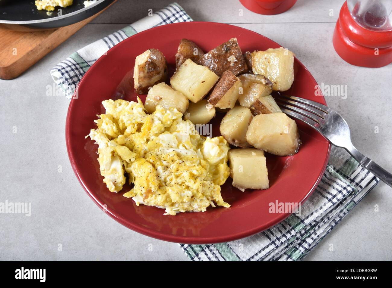 Overhead view of scrambled eggs with fried potato wedges Stock Photo ...
