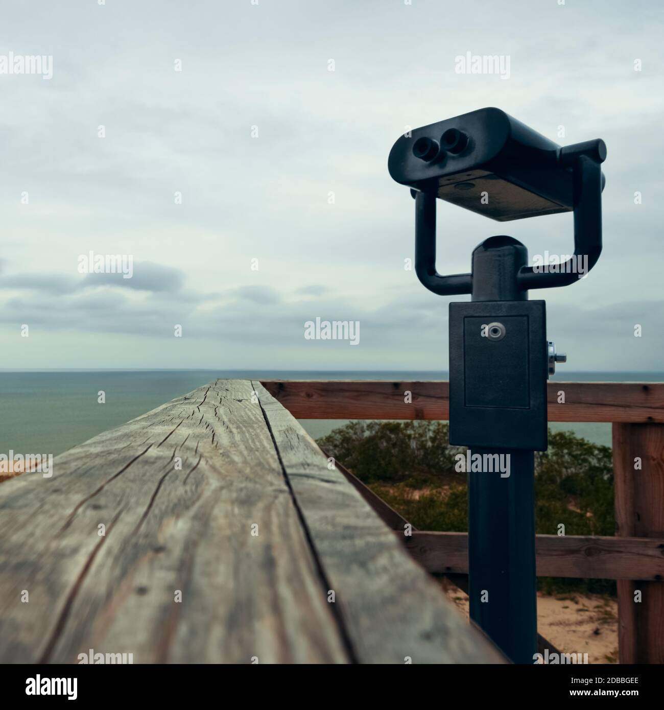 Binoculars for the observation deck on the beach at the wooden railing ...