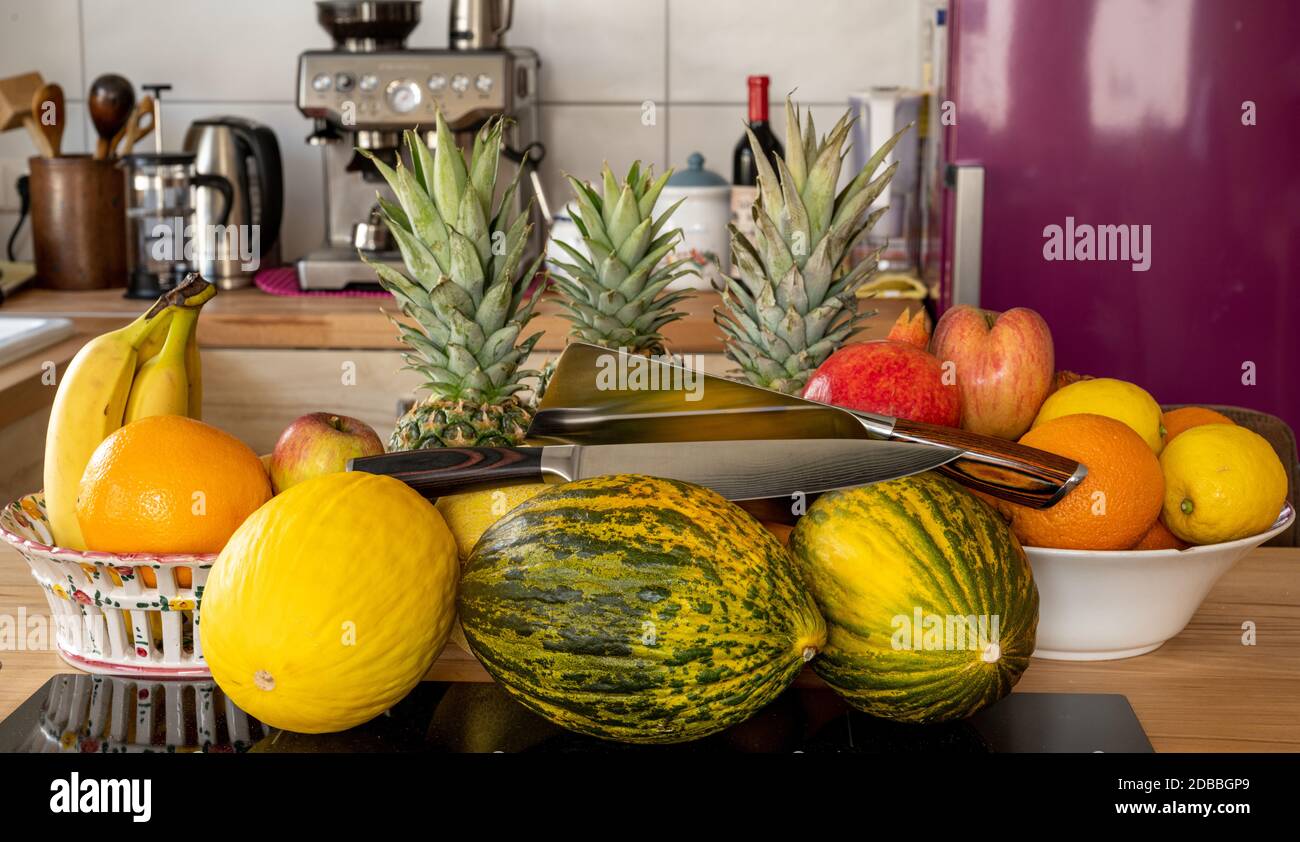 Many varieties of fresh and exotic fruits with a cleaver and a damascus ...
