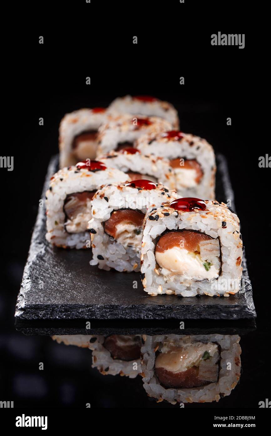 Japanese Traditional Cuisine. Sushi roll with sesame is served on a ...