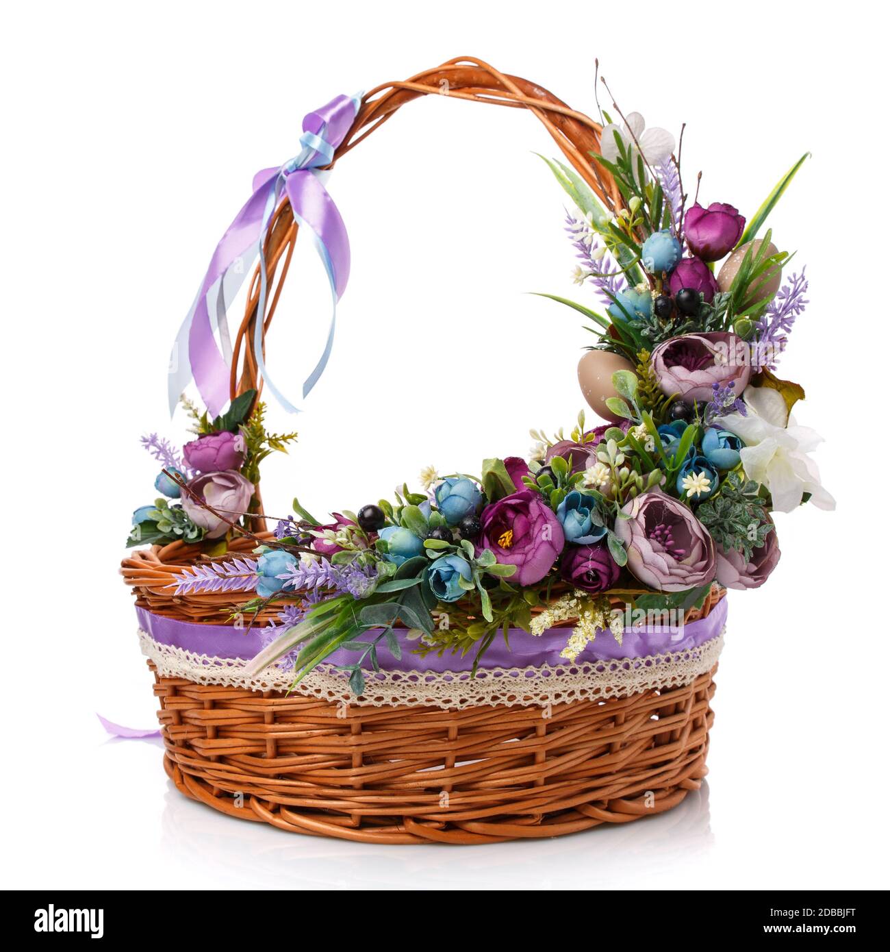 Easter basket. Brown wicker basket with colorful floral decor and ...