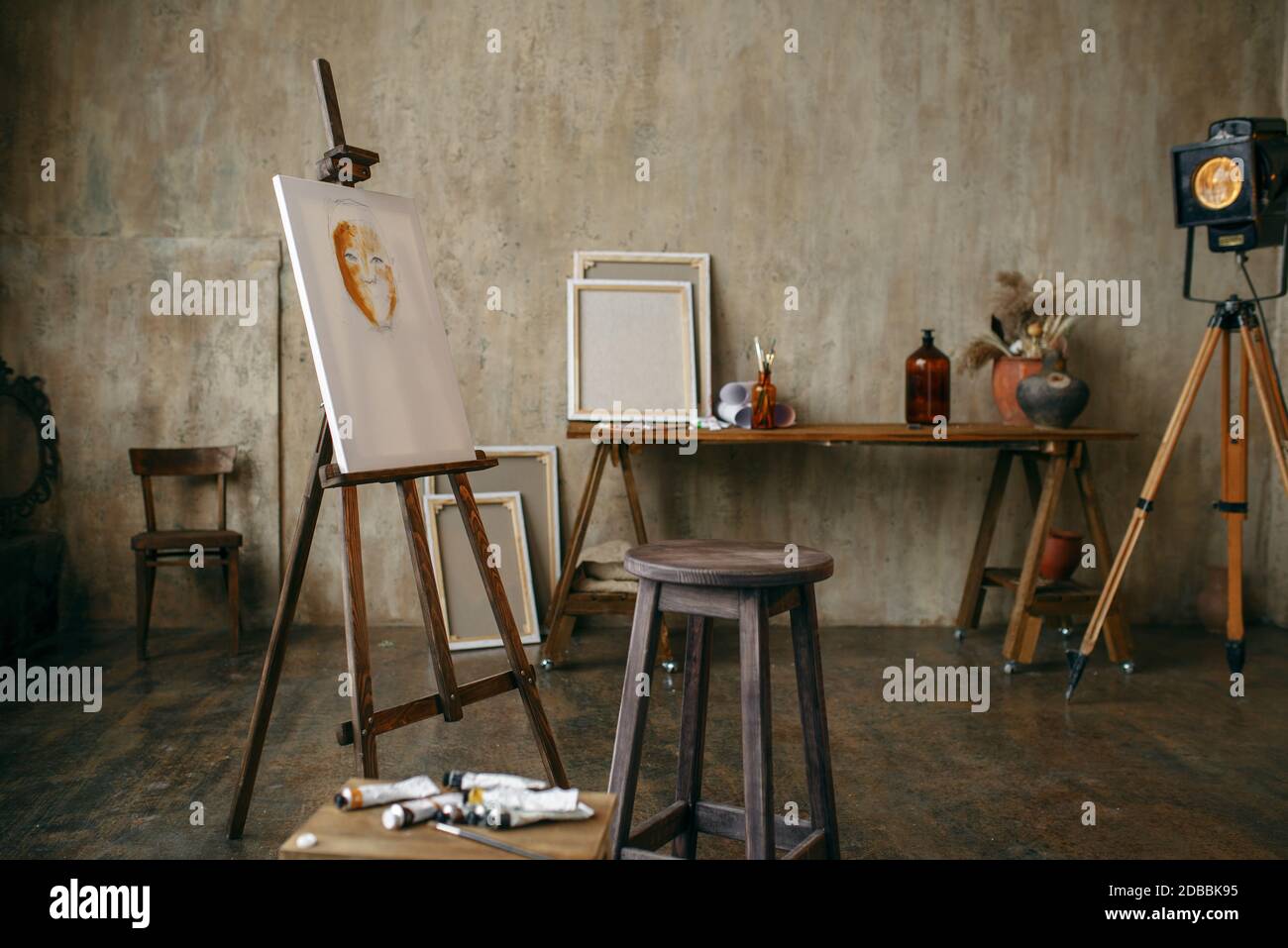 Painter tools and easel in art studio, nobody. Creative artist ...