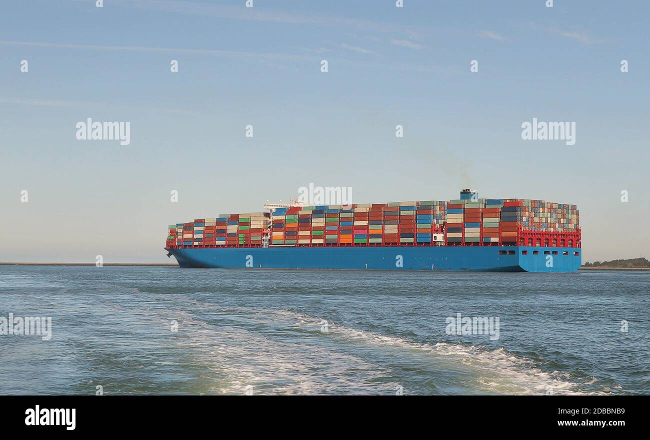 Container ship heading out to sea Stock Photo - Alamy
