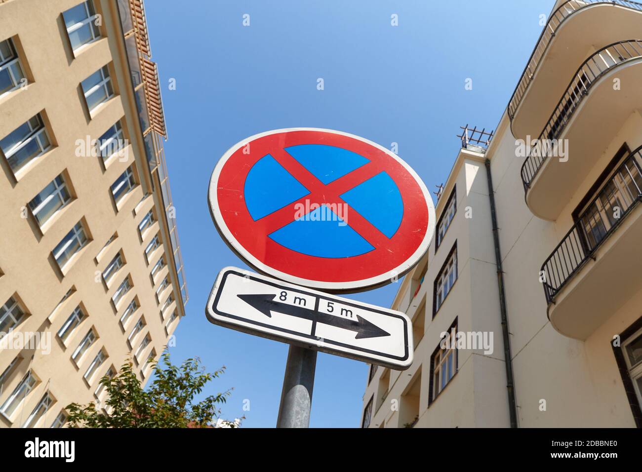 No stopping traffic sign on a narrow street between apartment buildings ...