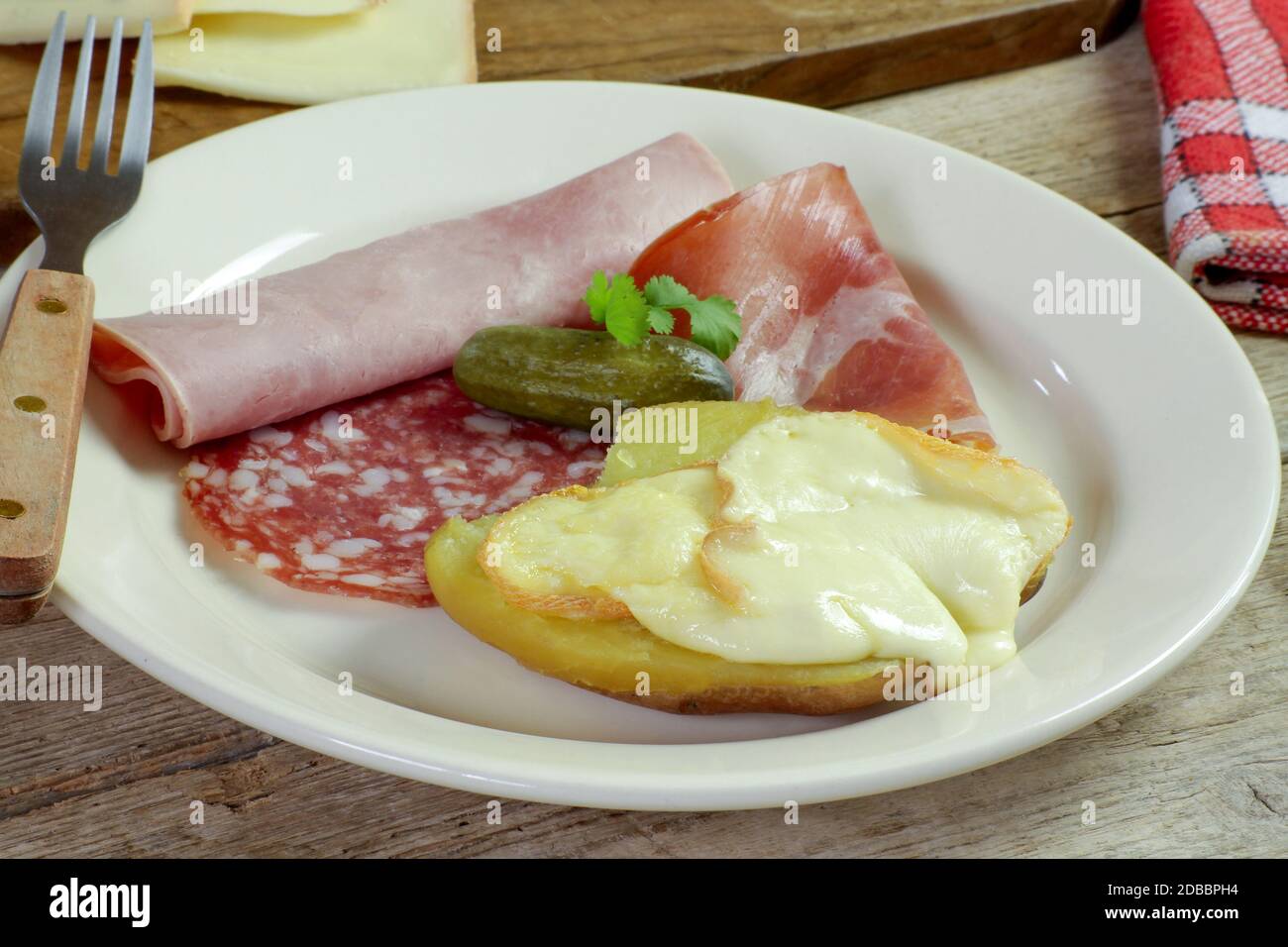 plate of raclette cheese, potatoes and cold cuts Stock Photo - Alamy