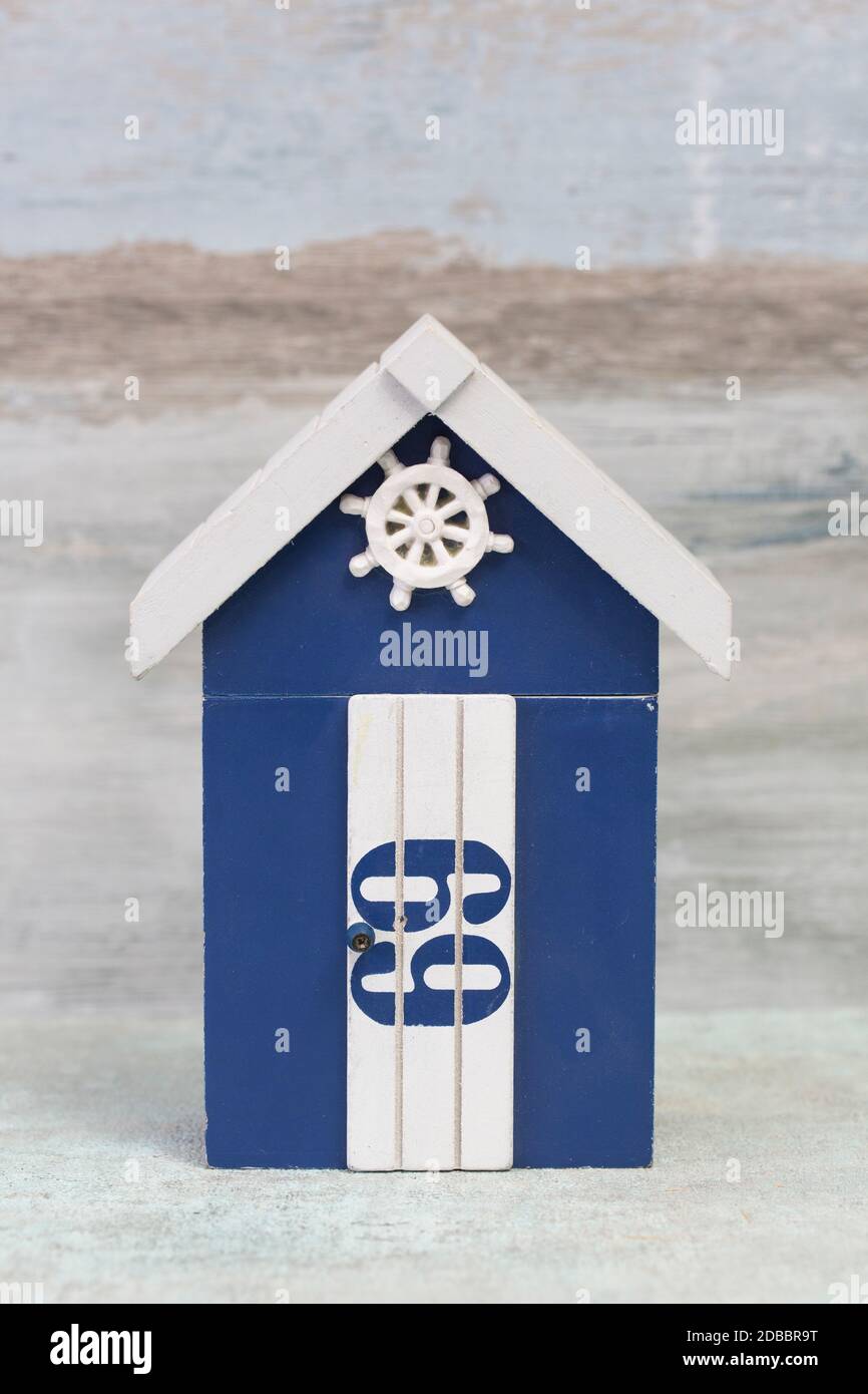 cute box in shape of a beach hut on wooden textured background Stock ...