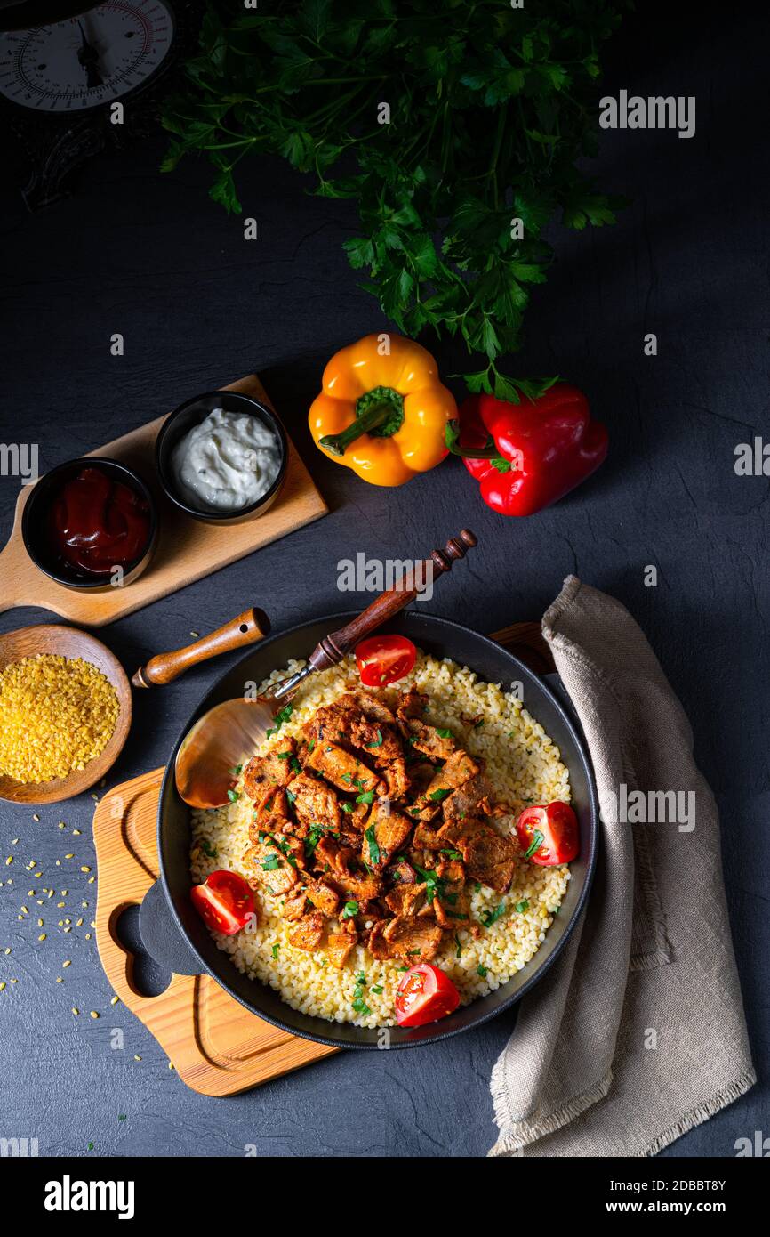 rustic bulgur pans with gratinated gyros and yoghurt Stock Photo - Alamy