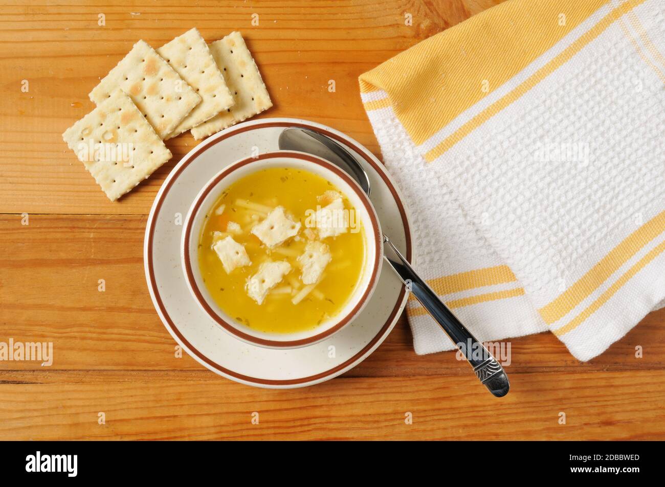 Chicken noodle soup with saltine crackers shot from above Stock Photo ...