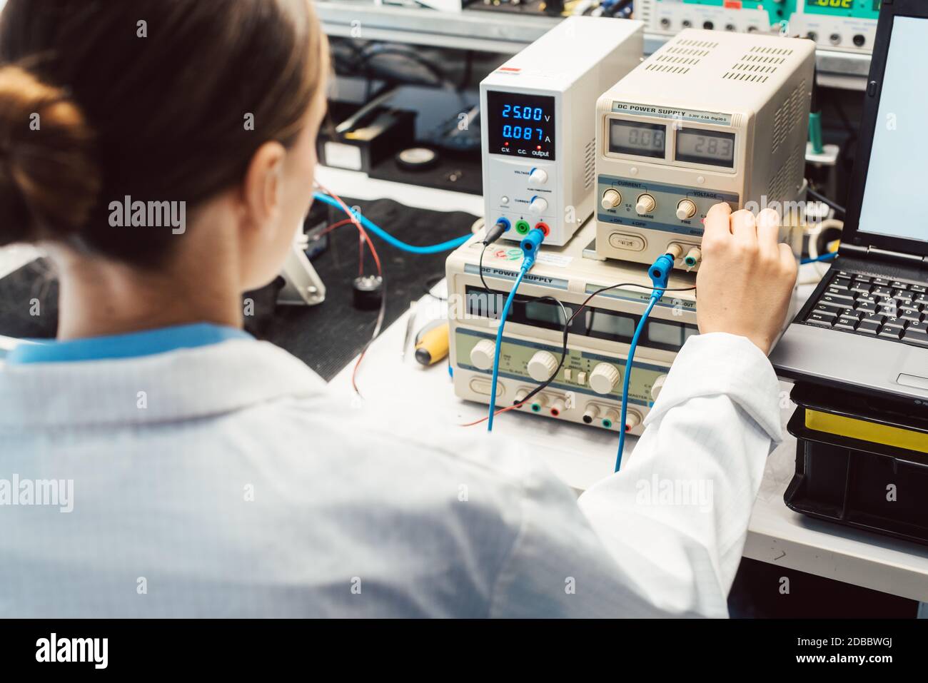 Engineer woman in electronics lab testing EMC compliance of a product ...