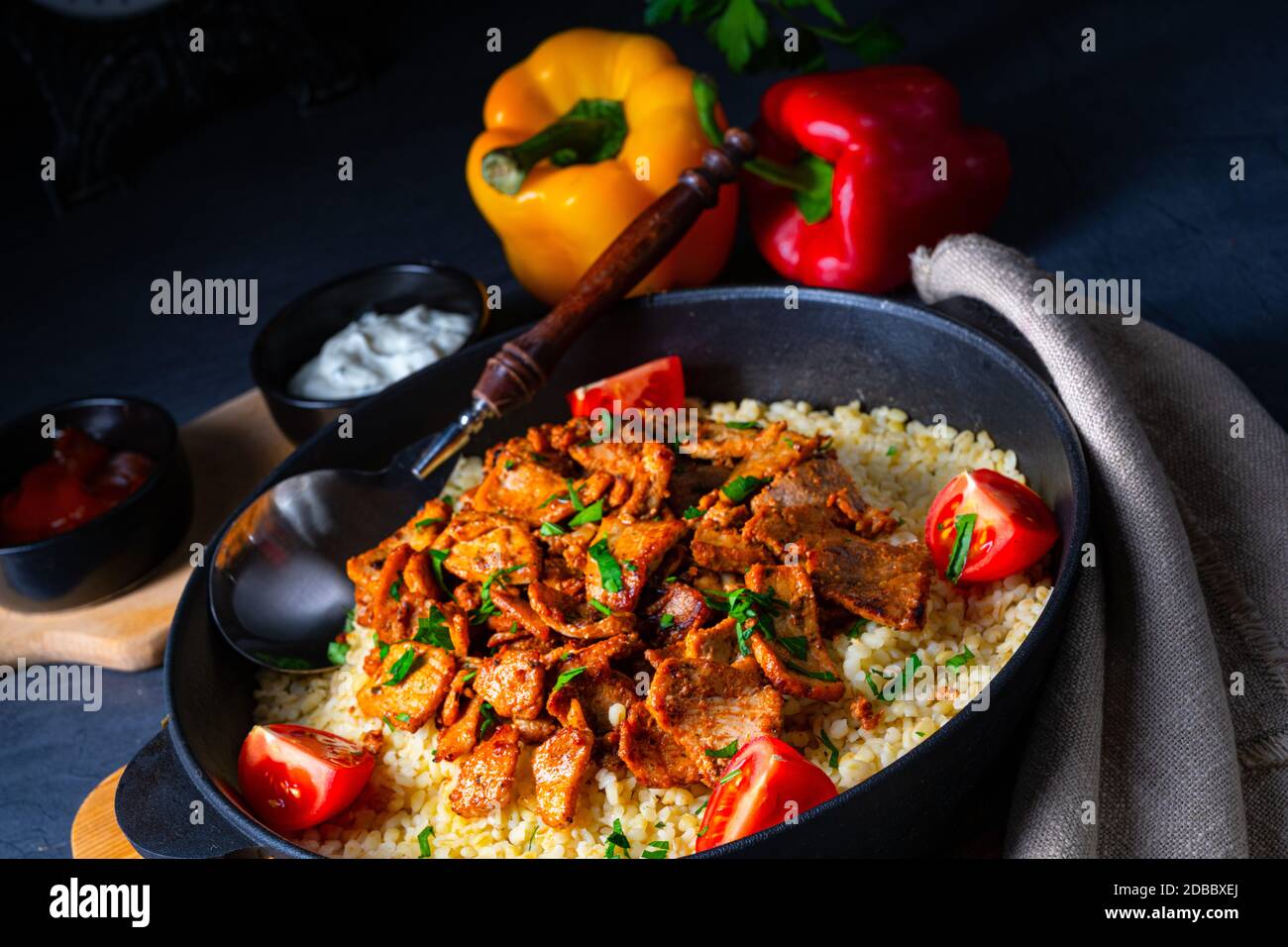 rustic bulgur pans with gratinated gyros and yoghurt Stock Photo - Alamy