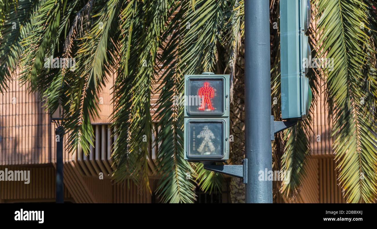 bright red pedestrian light on a street with palms in Spain Stock Photo ...