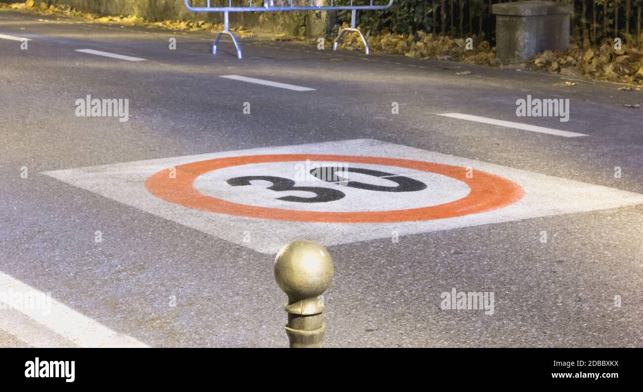 speed limit sign on a tarmac road by night in Italy Stock Photo - Alamy
