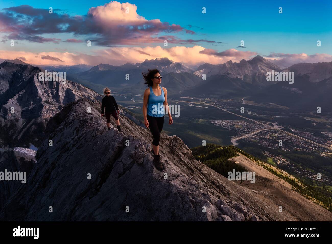 Adventurous Girl is hiking up a rocky mountain Stock Photo - Alamy
