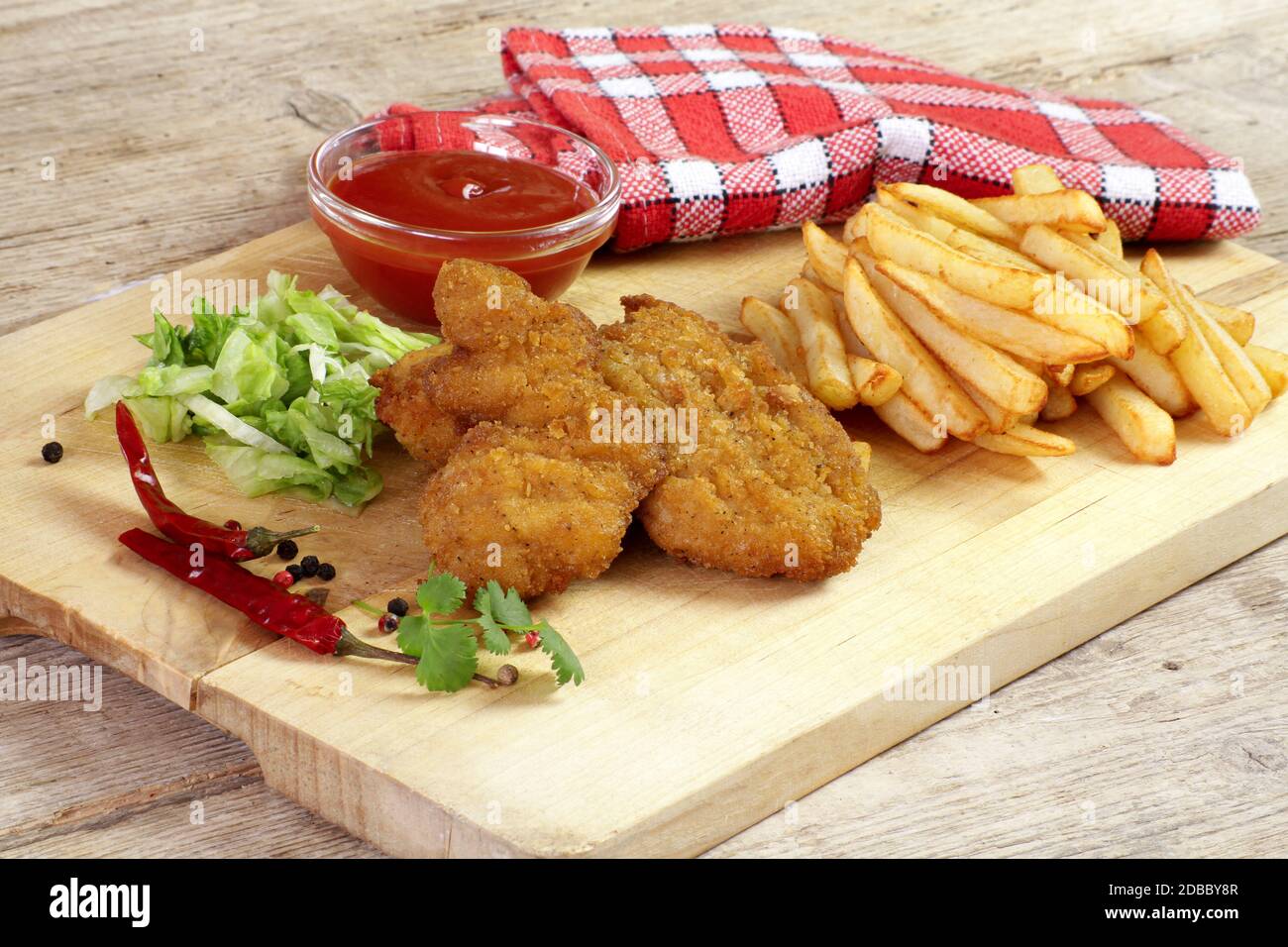 pieces of breaded chicken and fries Stock Photo - Alamy