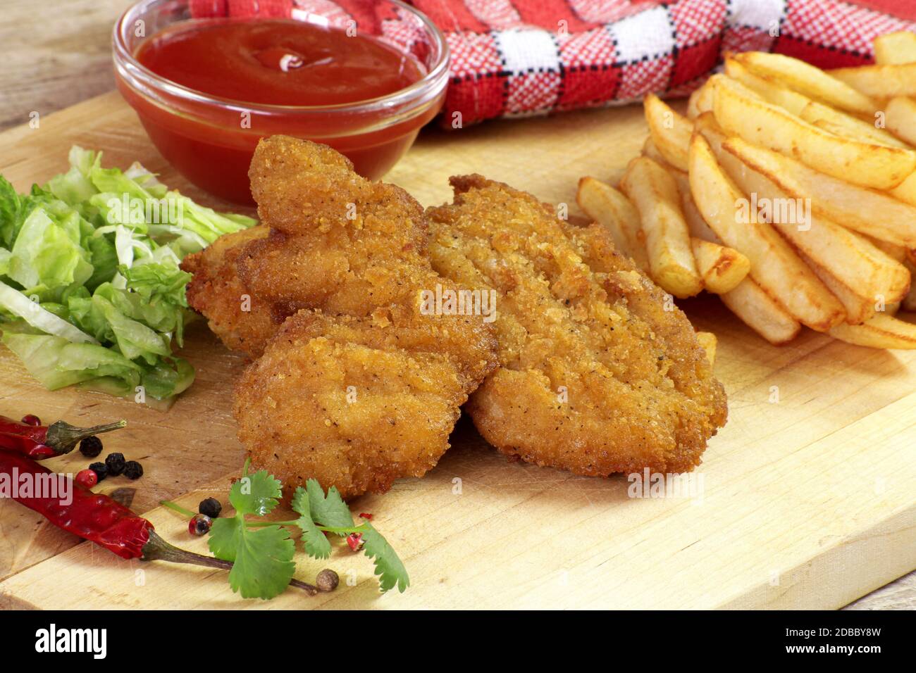 pieces of breaded chicken and fries Stock Photo - Alamy