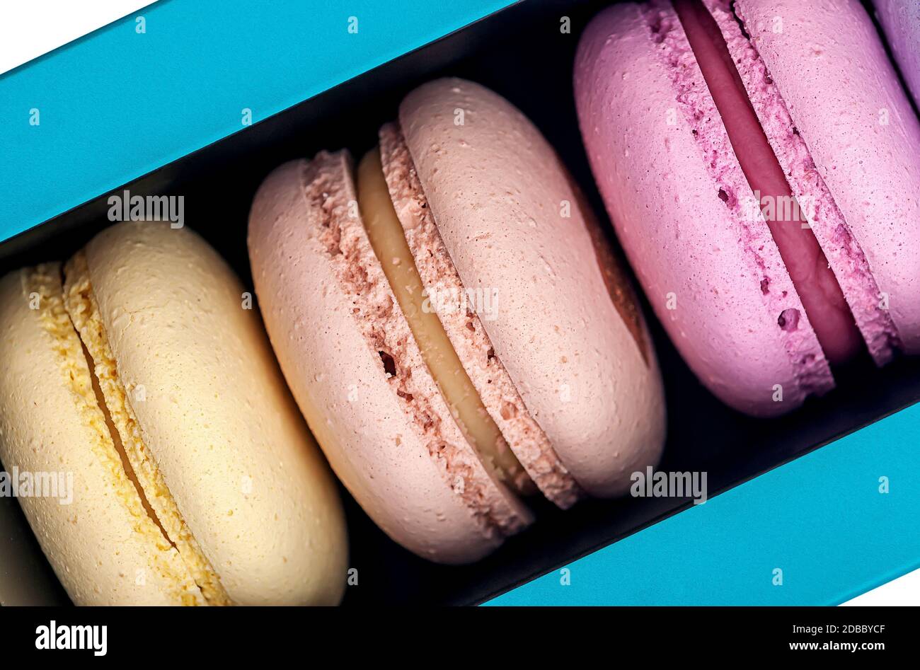Three macaroons in box closeup on white background Stock Photo - Alamy