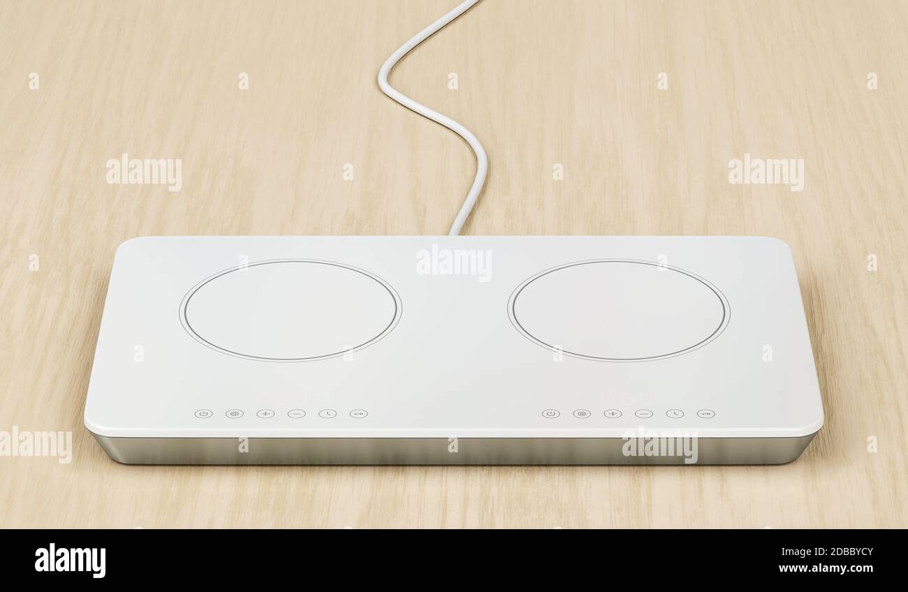 White induction cooktop on wood table Stock Photo - Alamy