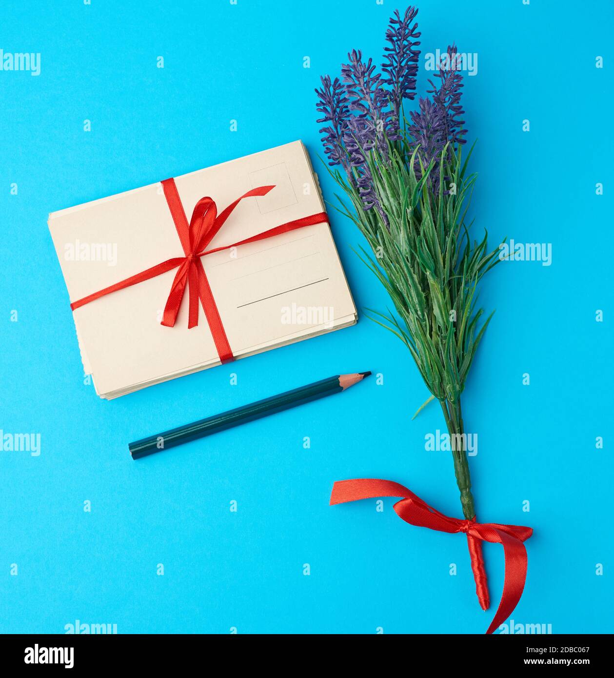 tied red silk ribbon rectangular vintage greeting card, blue background ...