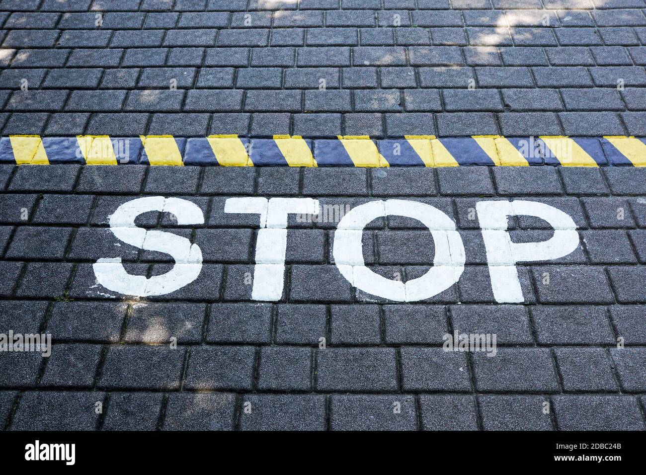 Stop written on floor asphalt concept image Stock Photo - Alamy