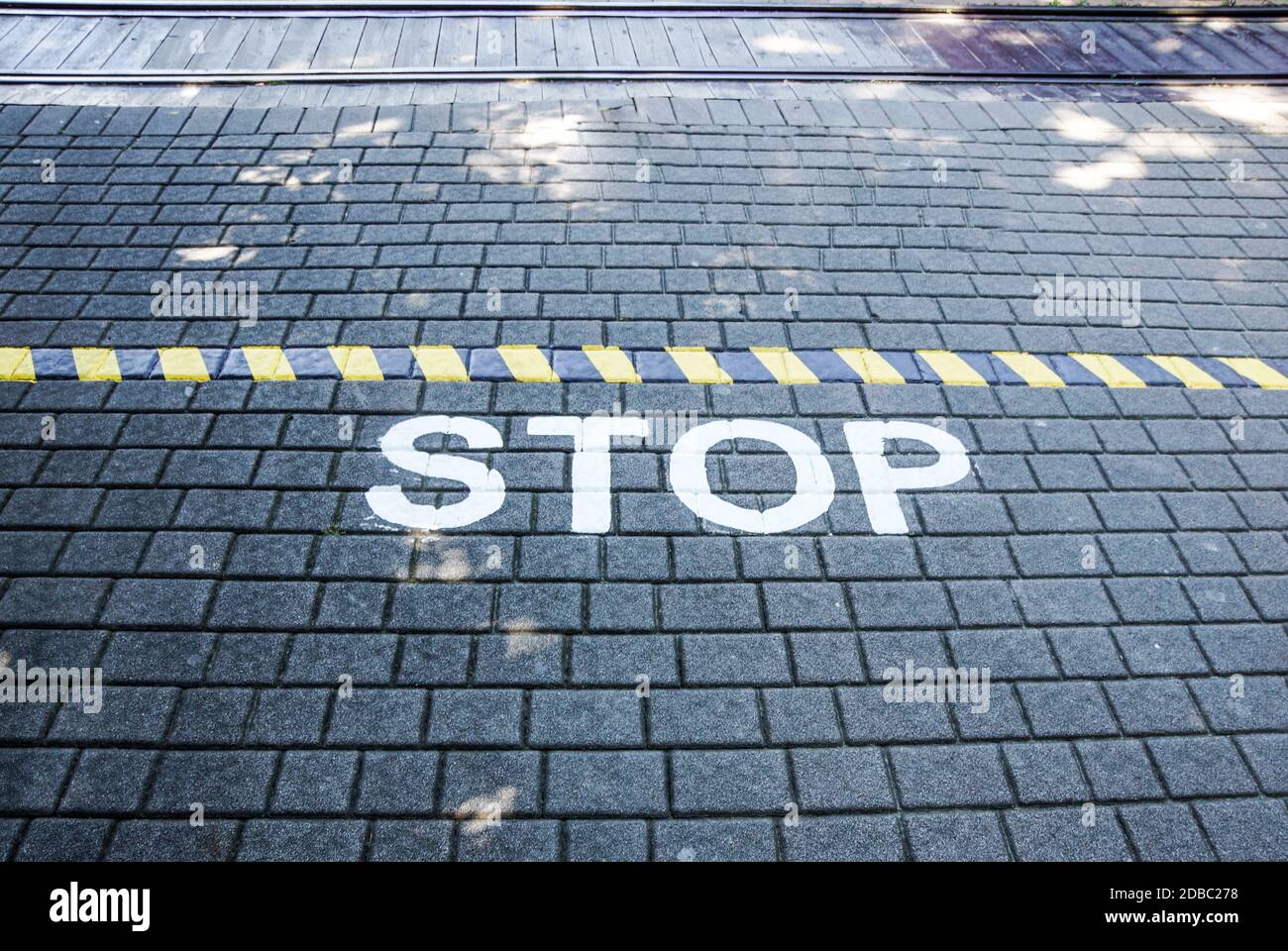 Stop written on floor asphalt concept image Stock Photo - Alamy