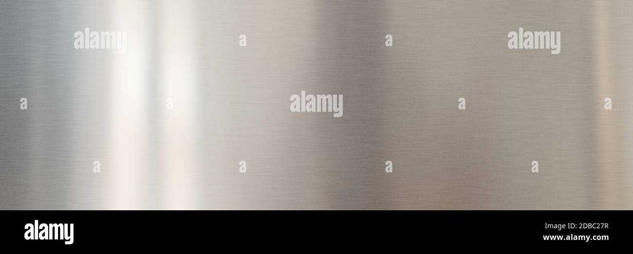 Silver colored brushed metal surface. Long metallic texture with light ...