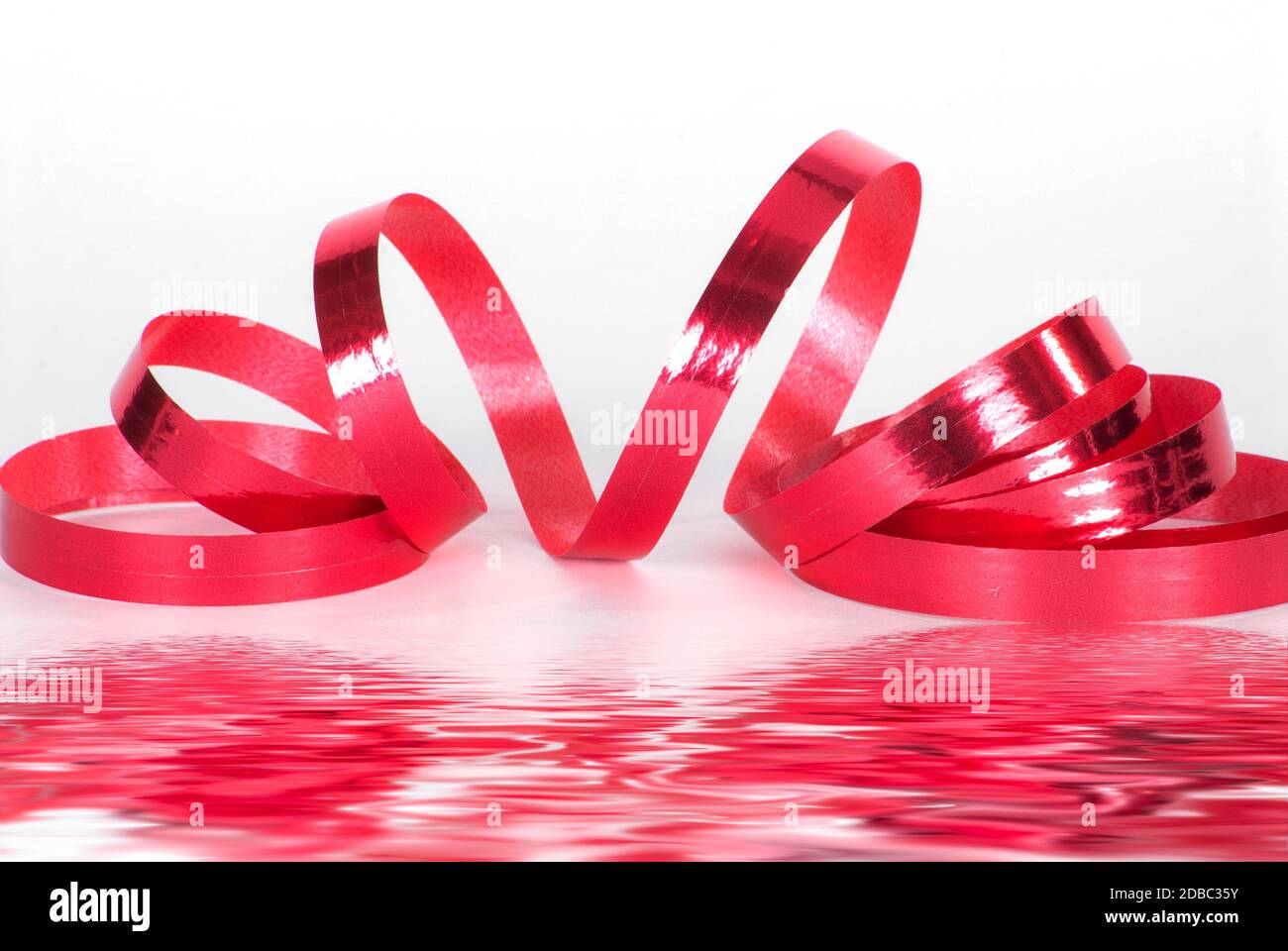 close-up of red ribbon isolated on white Stock Photo - Alamy