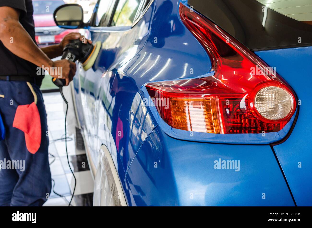 Auto polishing with machine.Blue car polish to remove and recover the ...