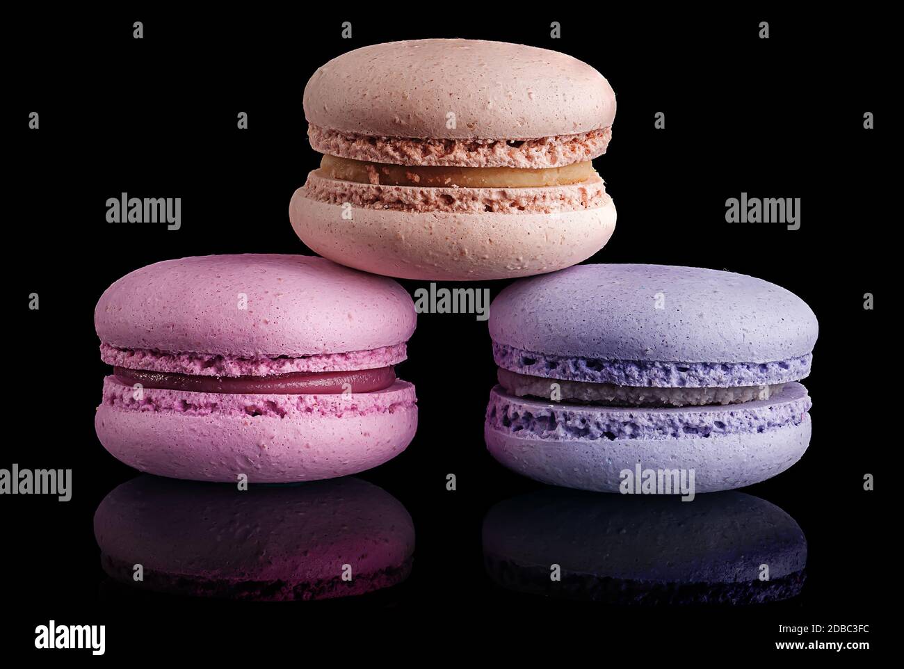 Three macaroon pyramid on black background with reflaction Stock Photo ...