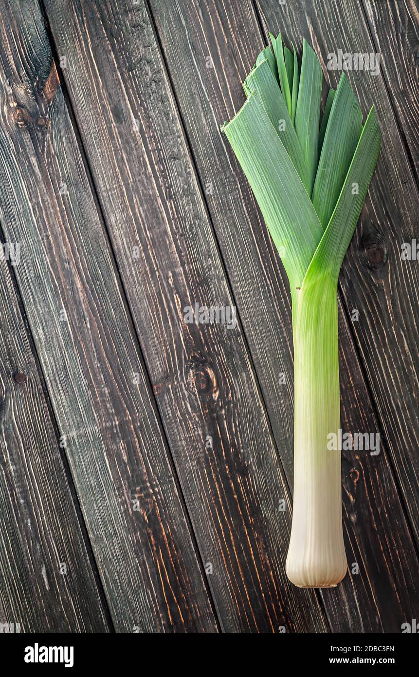 Leek on wooden background top view. Free space Stock Photo - Alamy