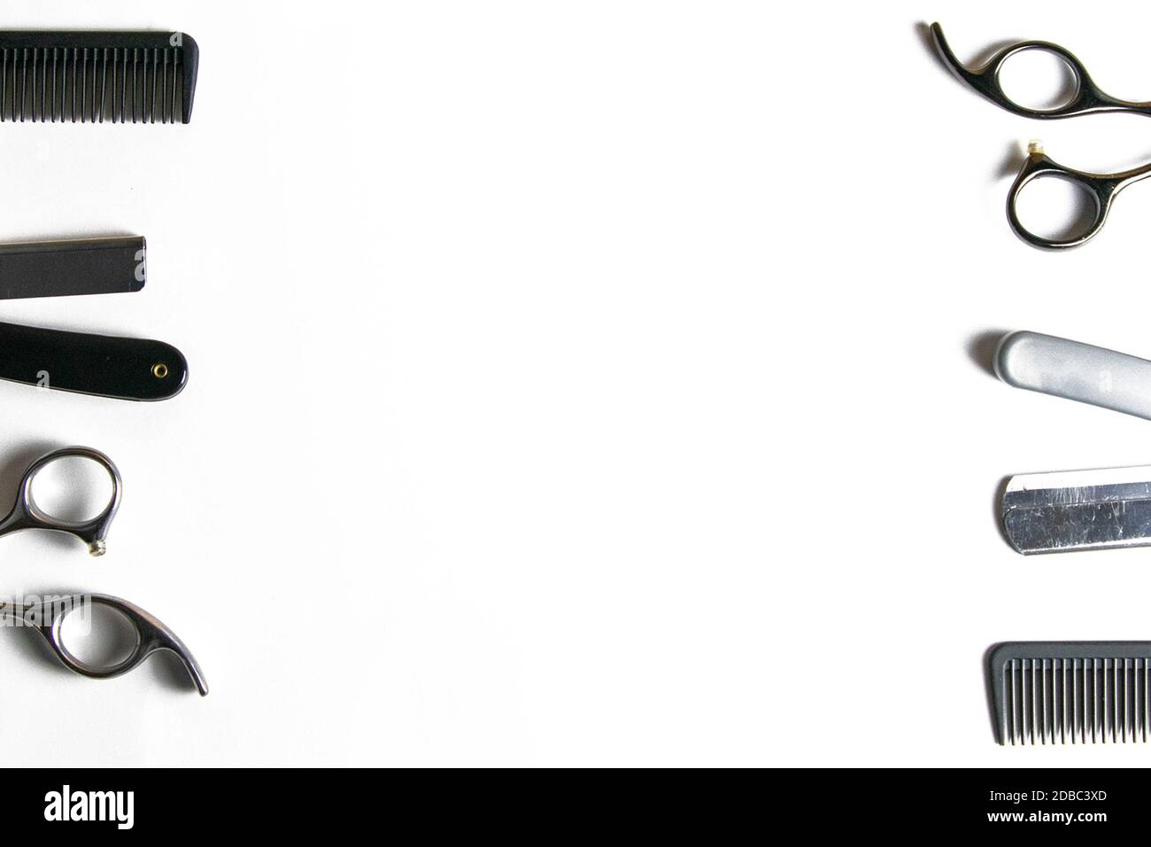 Scissors, hair clipper, combs, dangerous razor on a white sheet on ...