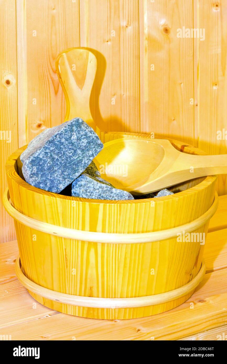 Wooden bucket with hot rocks in sauna Stock Photo - Alamy